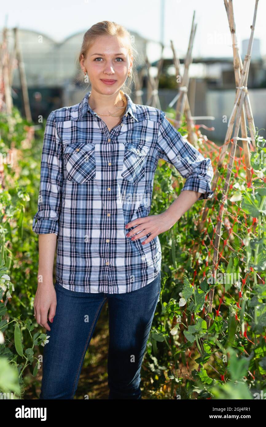 Woman gardener standing in homestead Stock Photo - Alamy