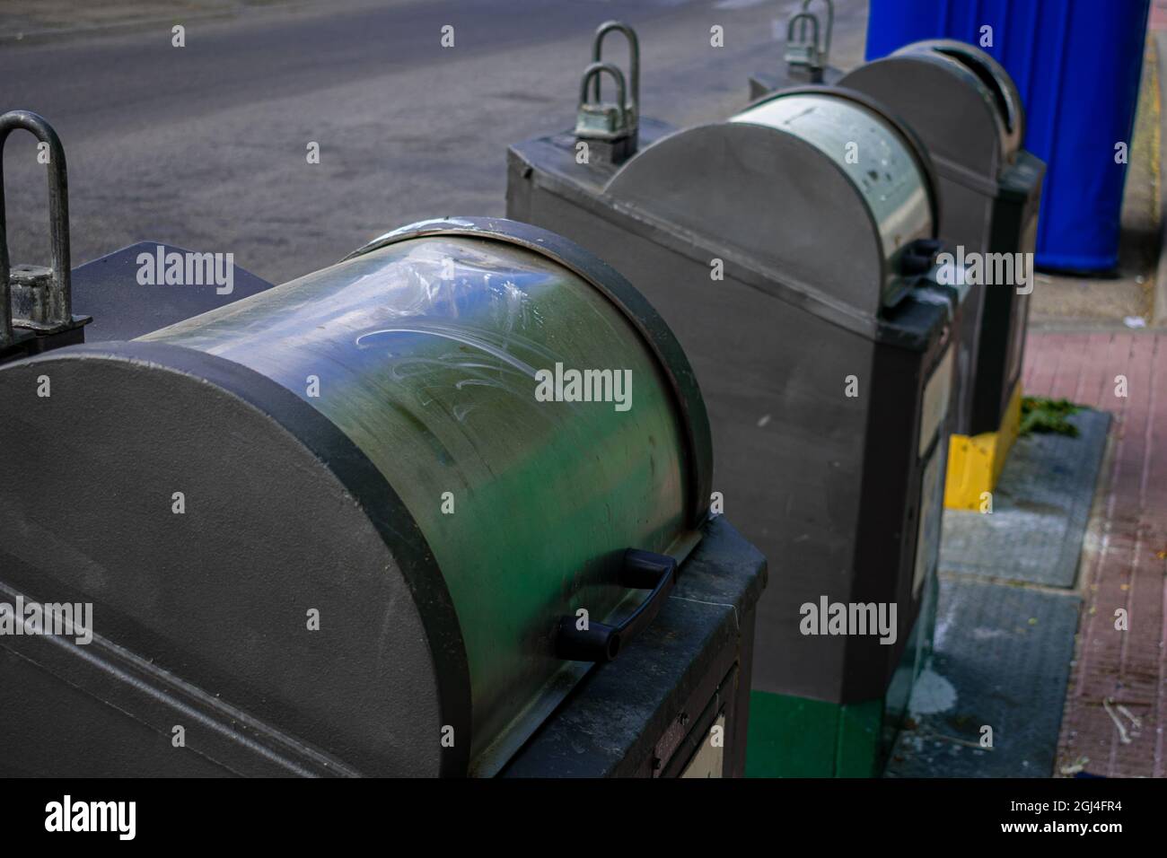Closeup shot of metallic recycle bins on a street Stock Photo - Alamy