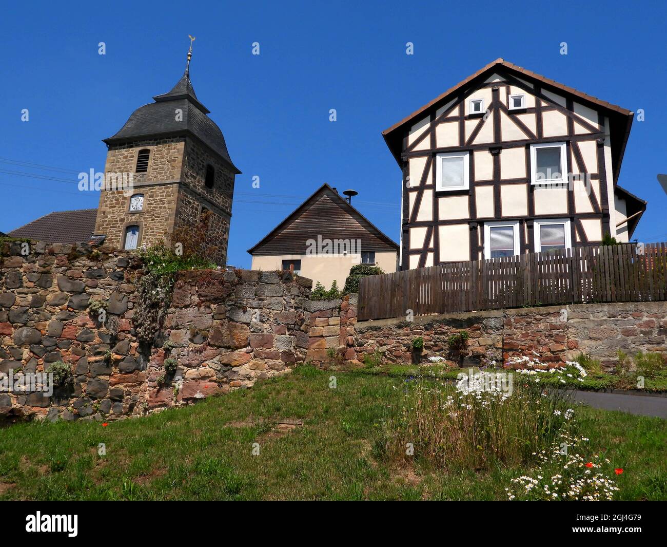 Low medieval brick tower and a whitewashed manor house with square ...