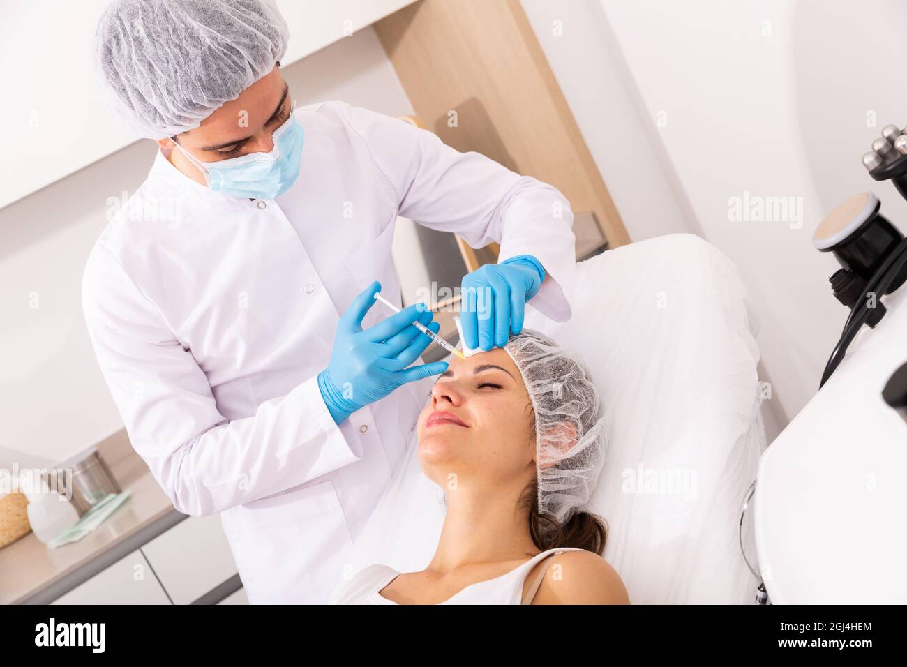 Woman getting facial contouring injections Stock Photo - Alamy