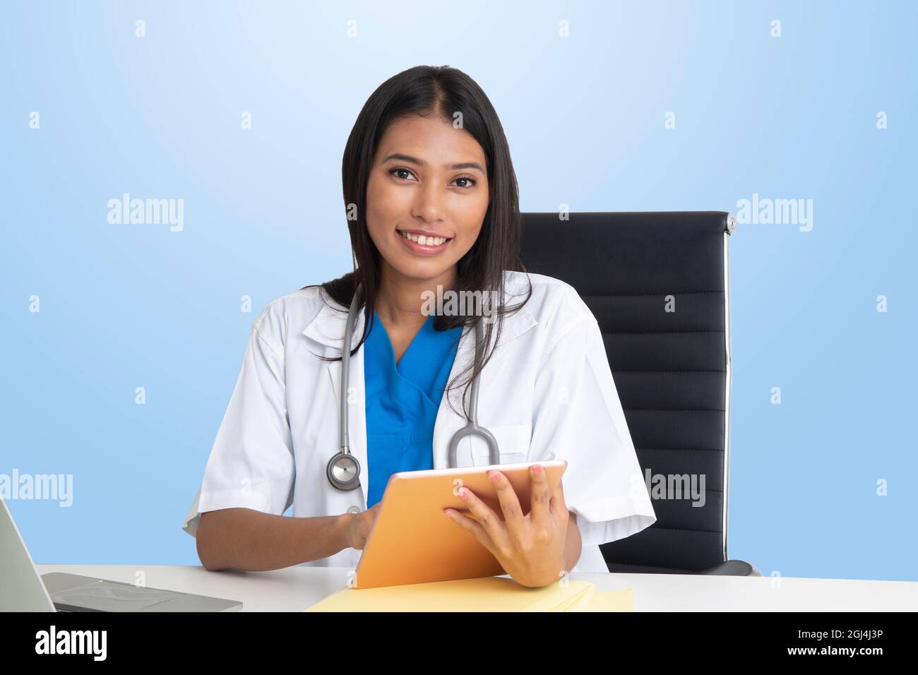 Female doctor sitting and smileing ready to serve anyone with warm ...