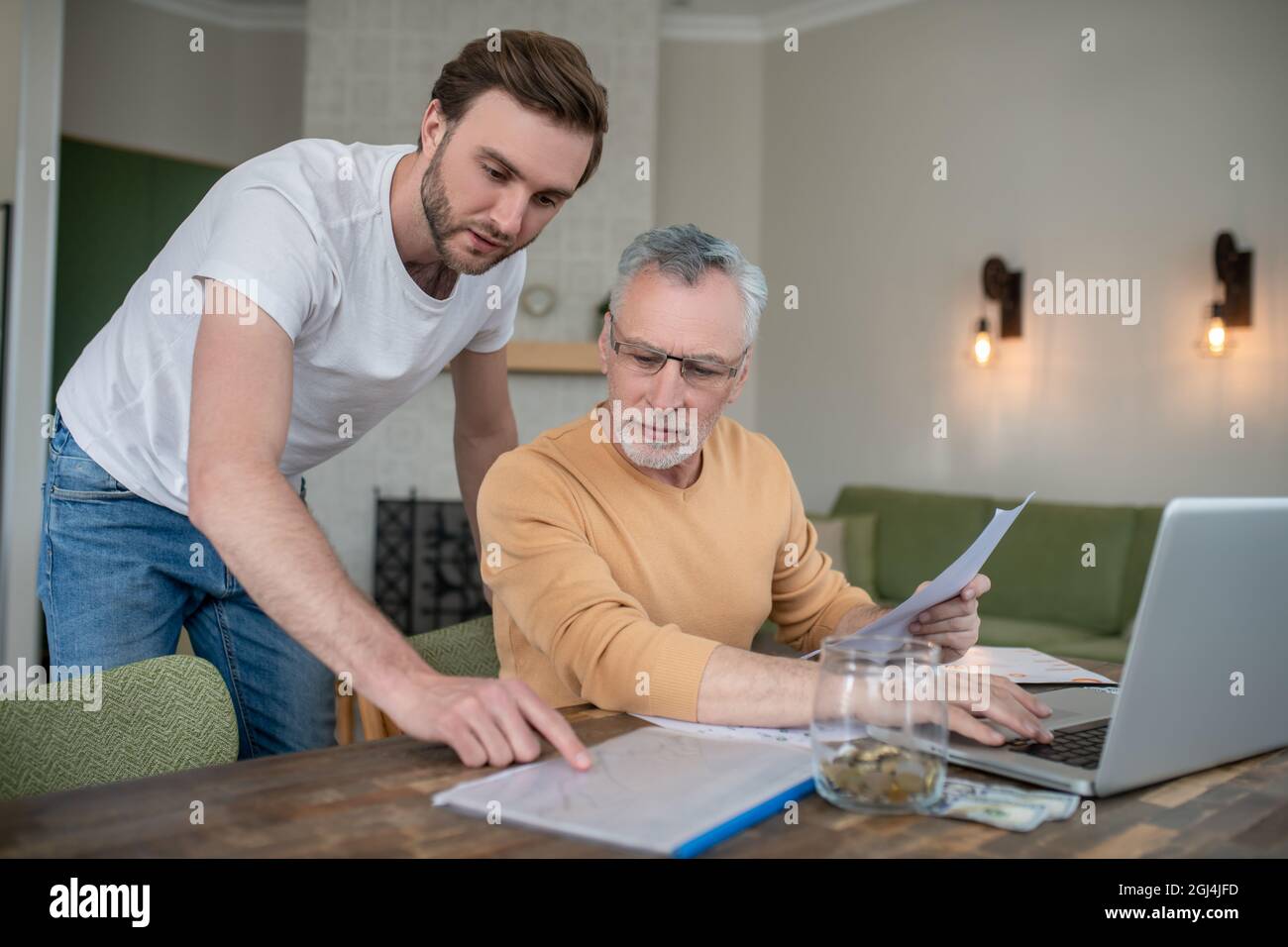 Two men working together on a project hi-res stock photography and ...