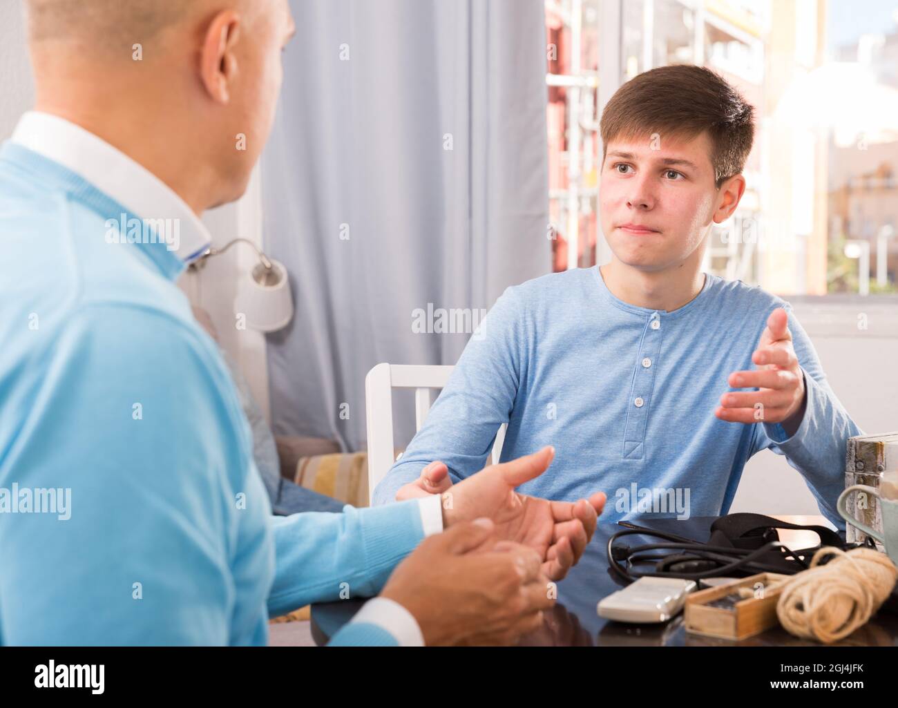 Guy and his father having conversation Stock Photo - Alamy