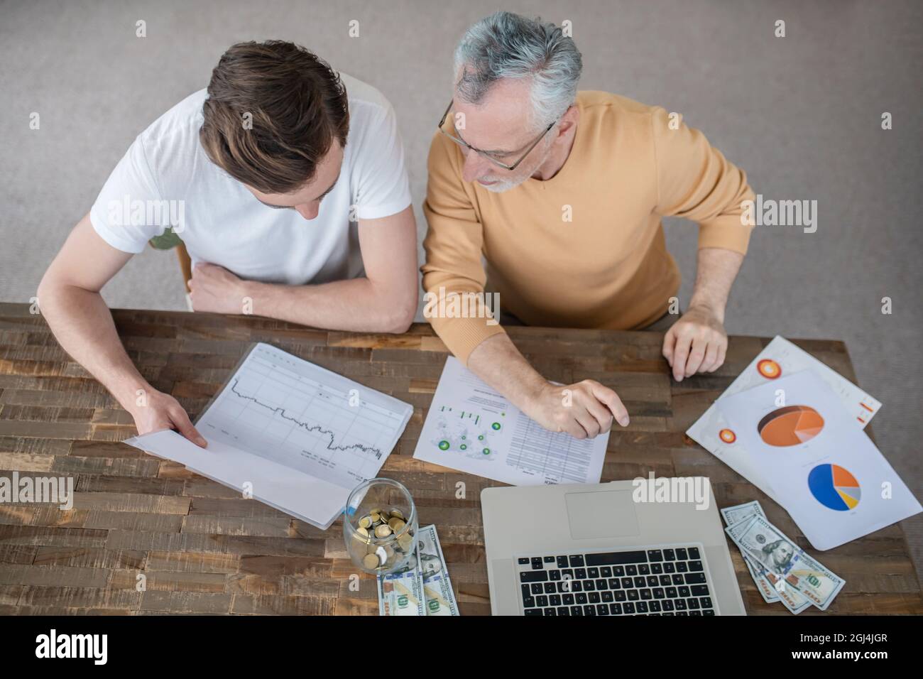 Two men working together on a project and looking concentrated Stock ...