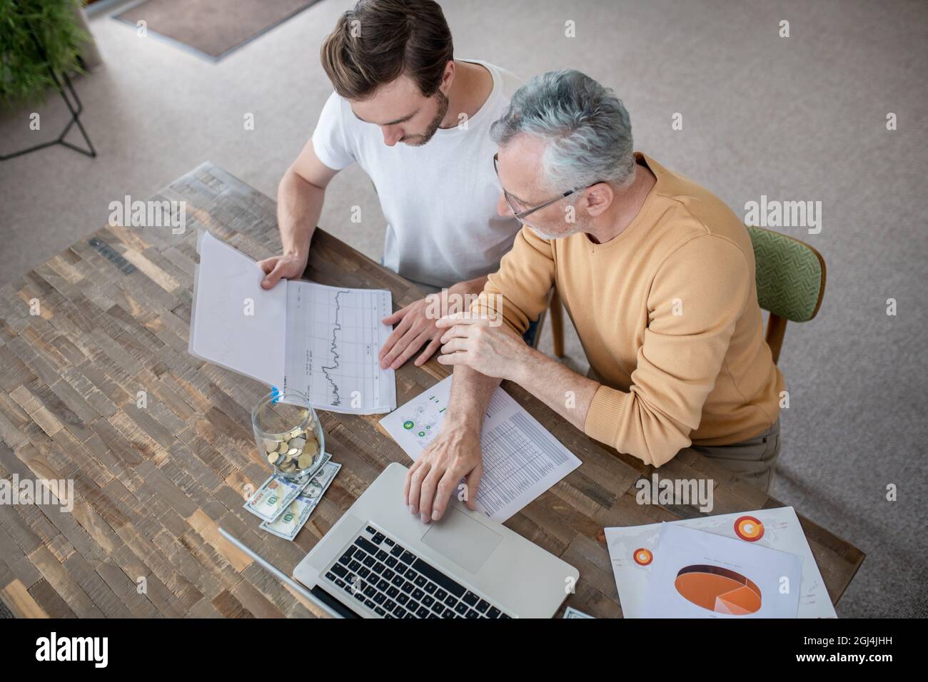 Two men working together on a project hi-res stock photography and ...