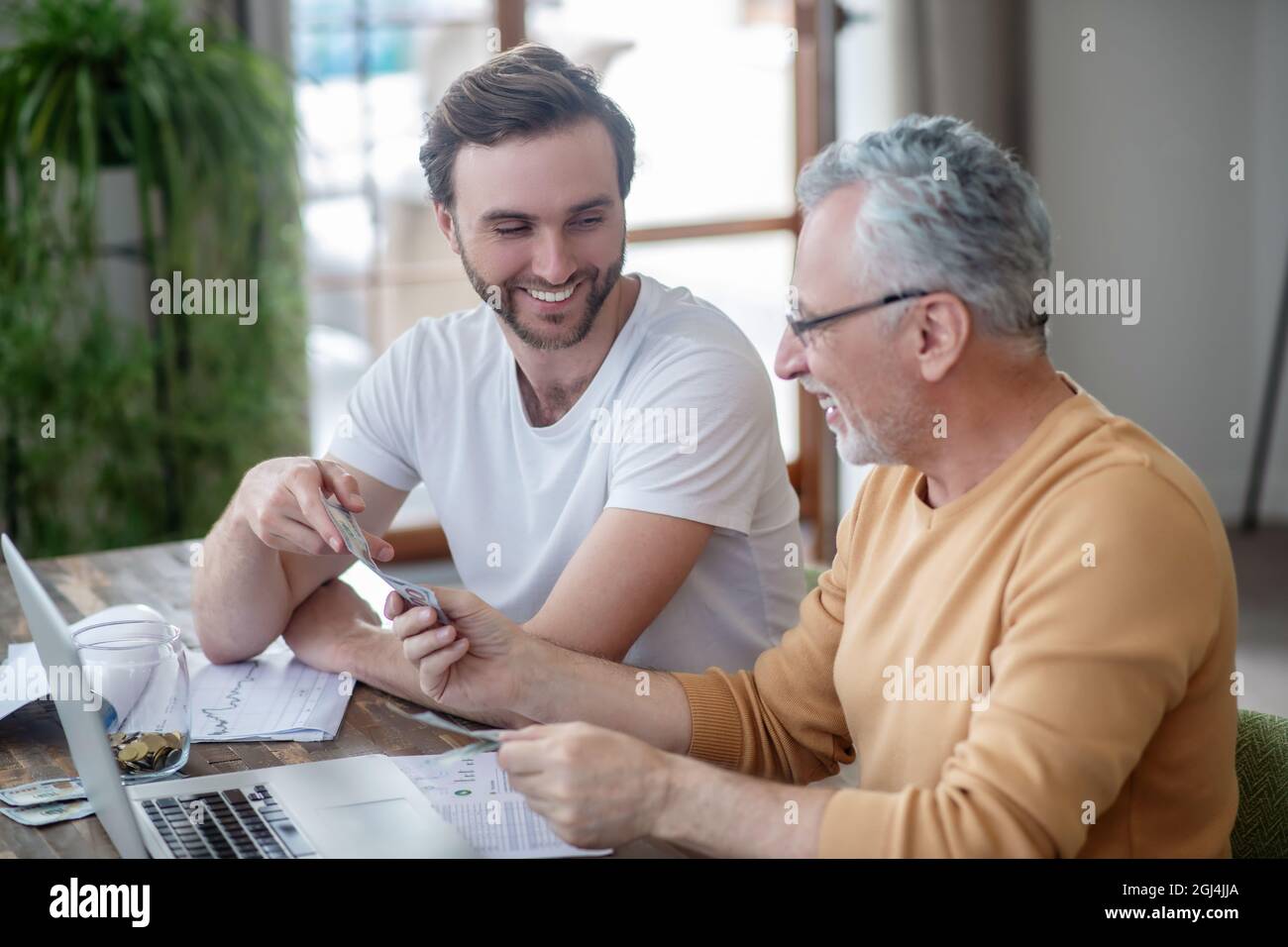 Two colleagues looking at each other and feeling good Stock Photo - Alamy