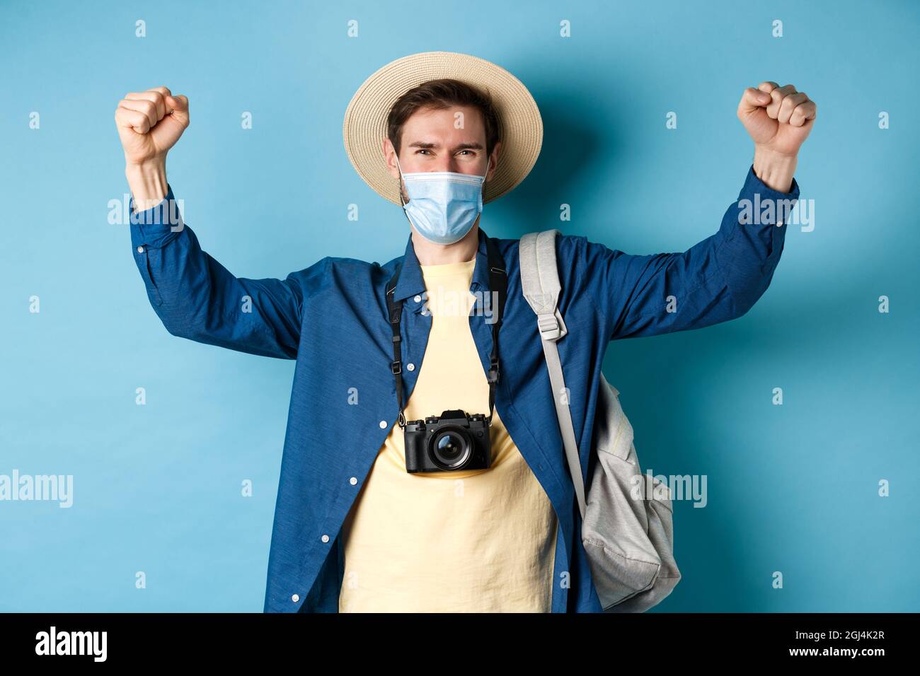 Covid-19 and summer holidays concept. Happy smiling tourist celebrating ...