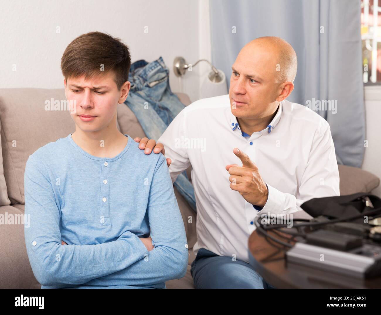 Father scolding his turned away son Stock Photo - Alamy