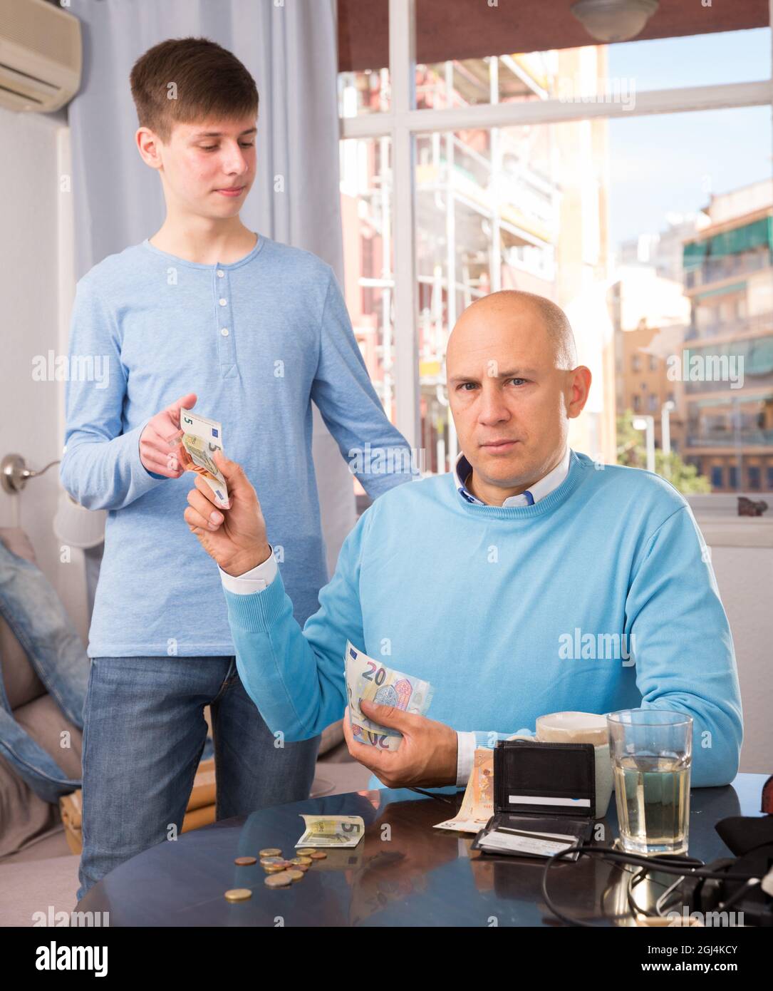 Father giving money to son Stock Photo - Alamy