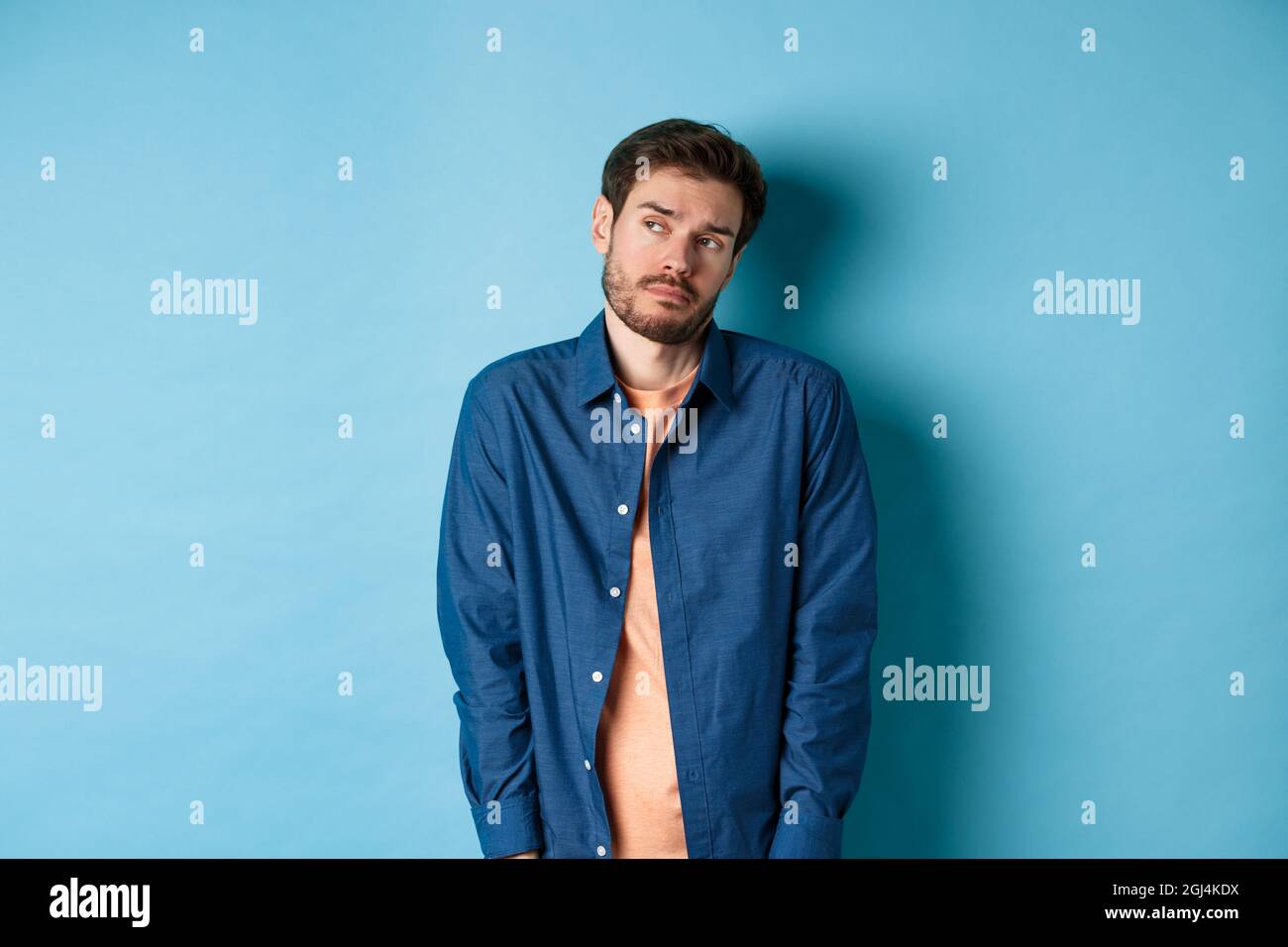 Reluctant and sad man feeling upset, looking aside at empty space with ...