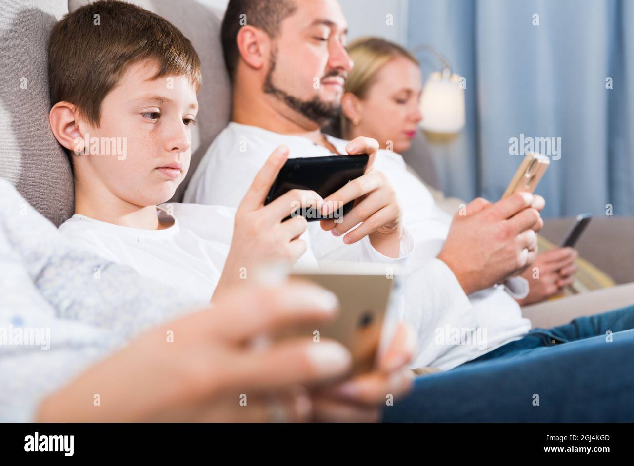 Modern family with smartphones at home Stock Photo - Alamy