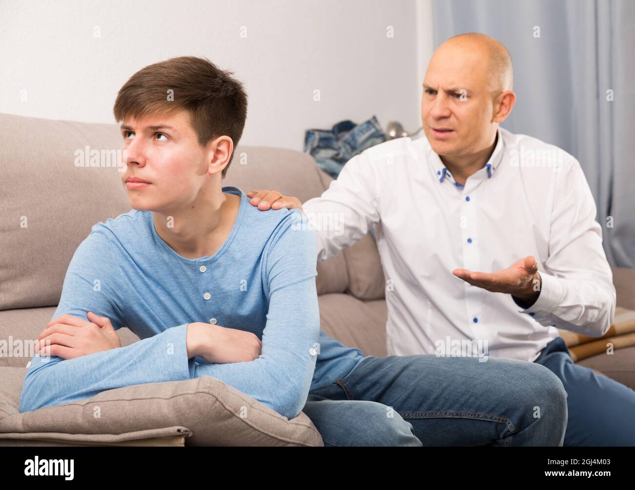 Father scolding his turned away son Stock Photo - Alamy