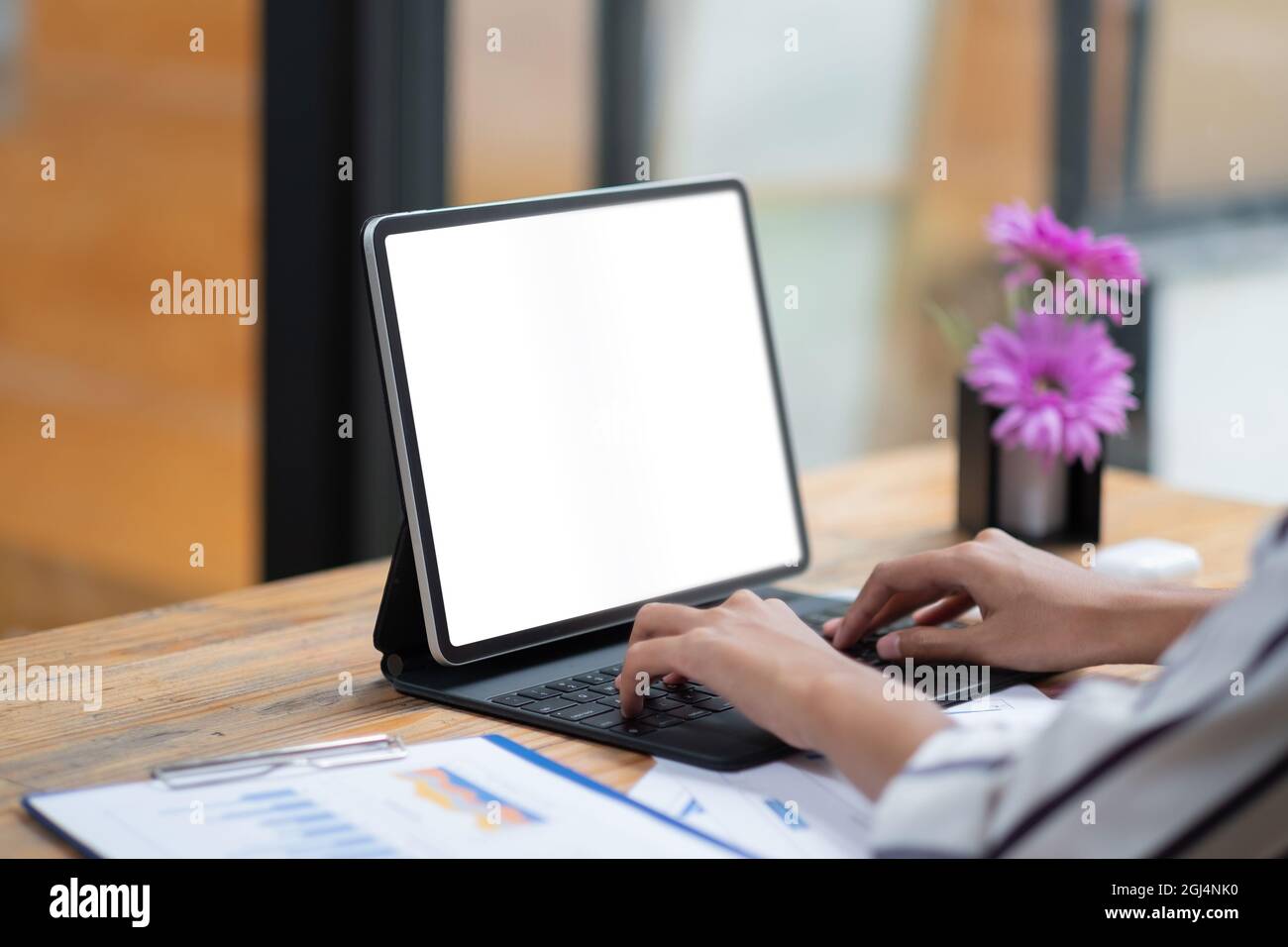 Close up view of female hands typing on a digital tablet keyboard with ...