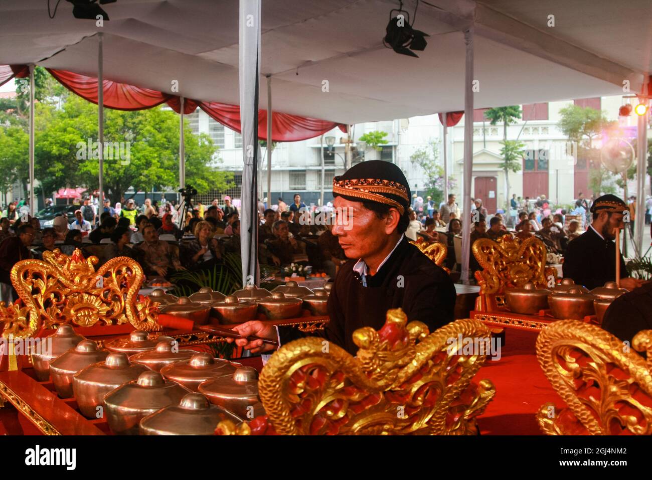 A bonang musician or player, one of the gamelan musical instruments, is ...