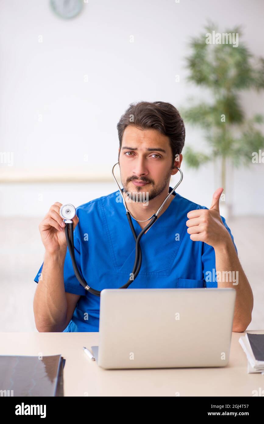 Young doctor working in the clinic Stock Photo - Alamy