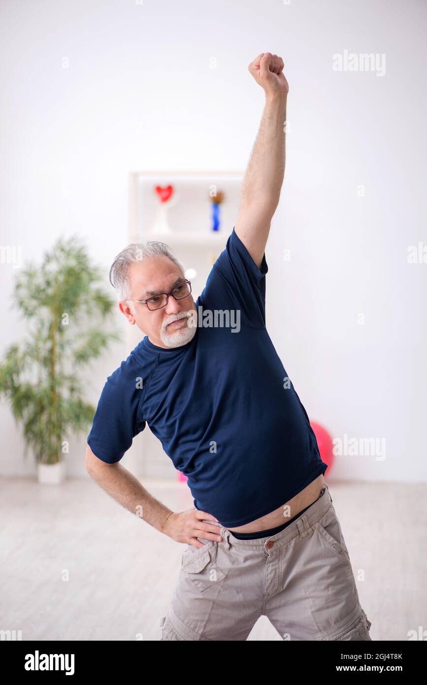 Old man doing sport exercises at home Stock Photo - Alamy