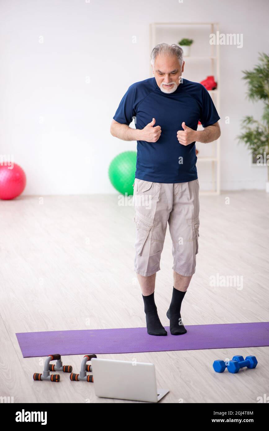 Old man doing sport exercises at home Stock Photo - Alamy
