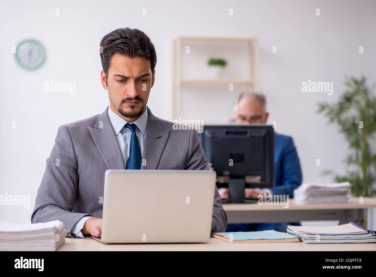 Two male employees working in the office Stock Photo - Alamy