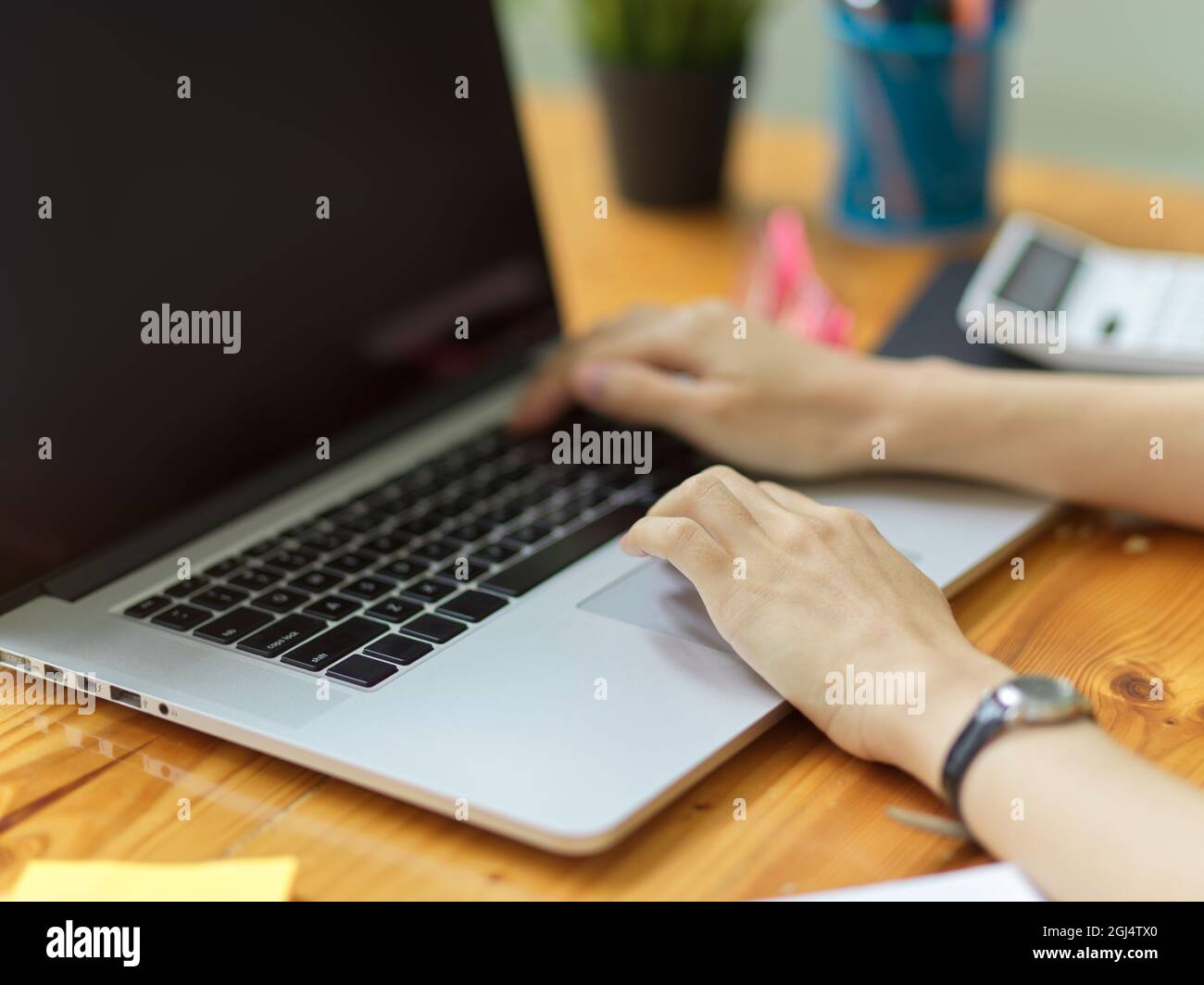 Close up of woman's hand typing on keyboard of laptop computer on ...