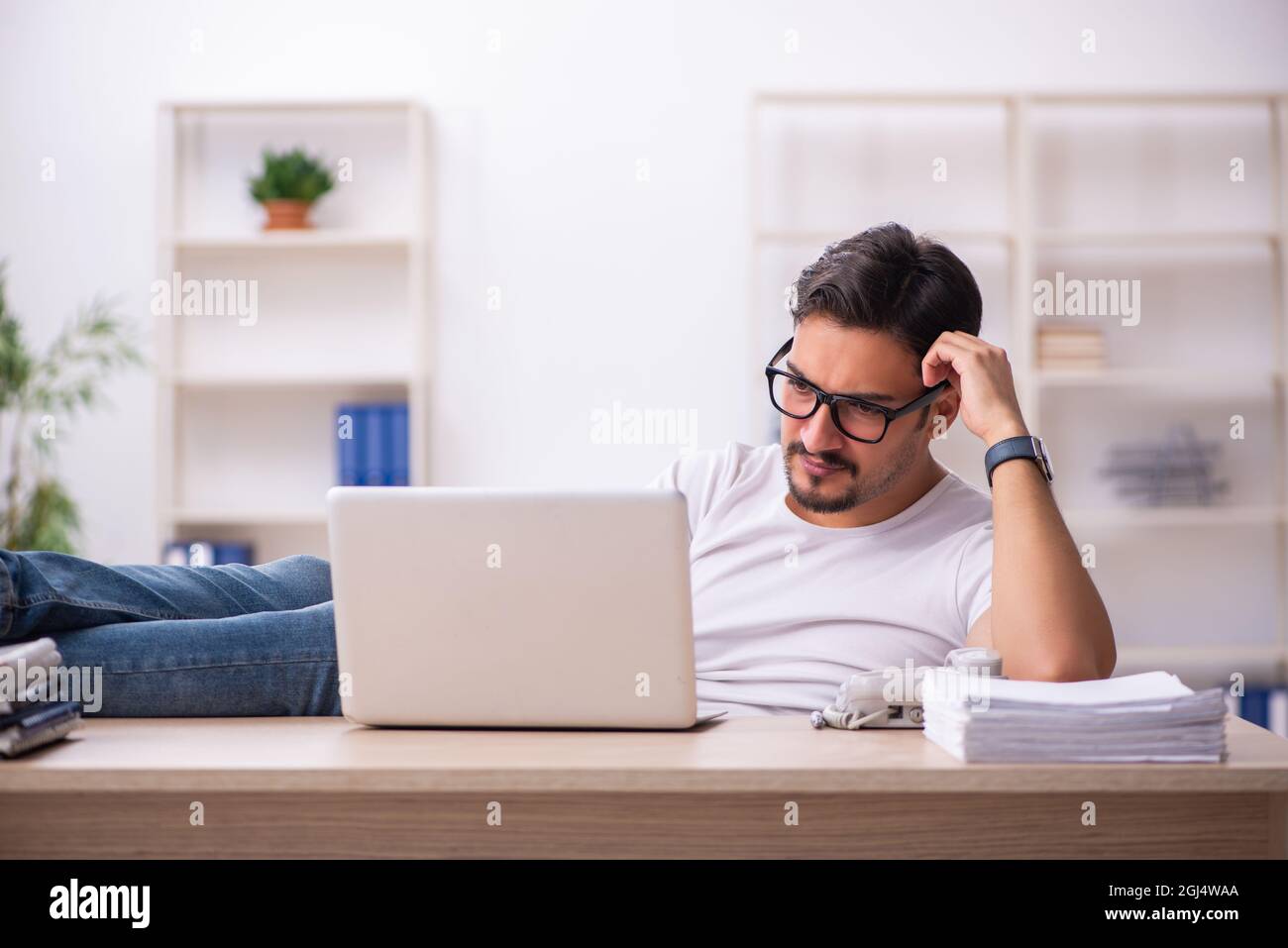 Young student employee at workplace Stock Photo - Alamy