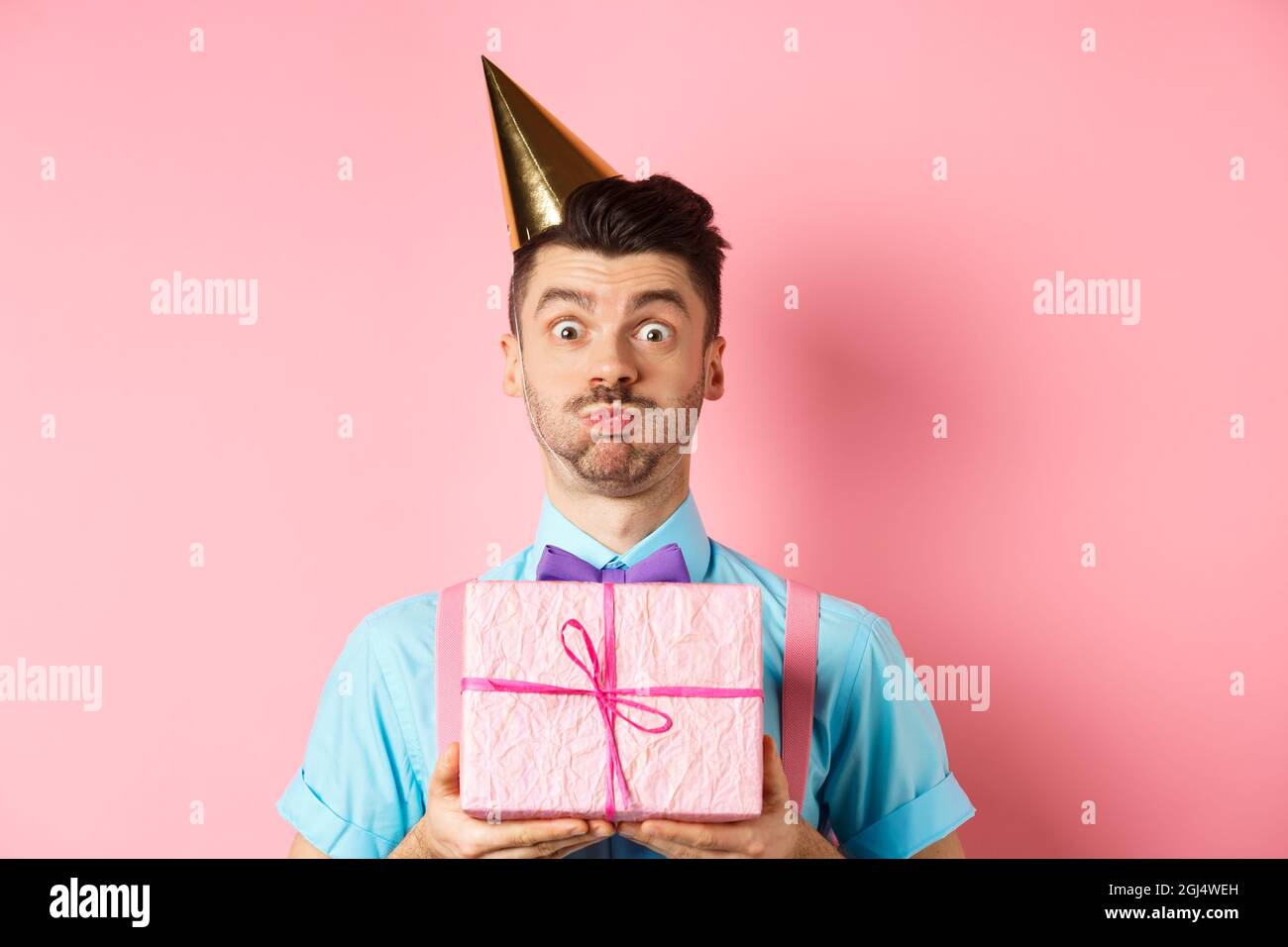 Holidays and celebration concept. Funny guy staring at camera surprised ...