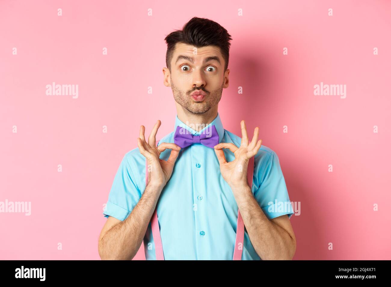 Handsome and funny young man pucker lips for kiss, showing his classy ...