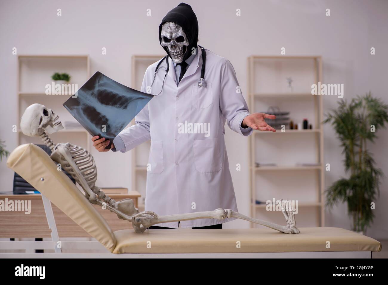 Devil doctor radiologist examining skeleton patient at the hospital ...