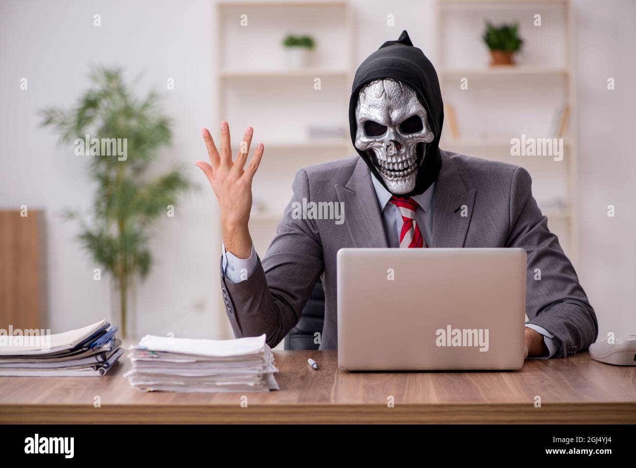 Devil businessman employee working in the office Stock Photo - Alamy