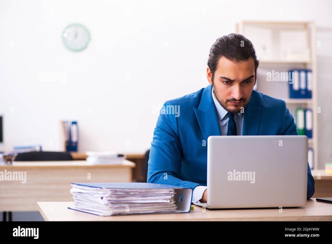 Young employee and too many work in the office Stock Photo - Alamy