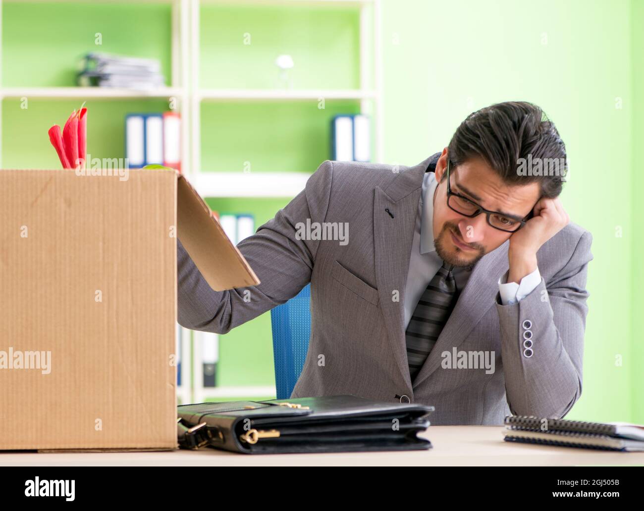 The male employee collecting his stuff after redundancy Stock Photo - Alamy