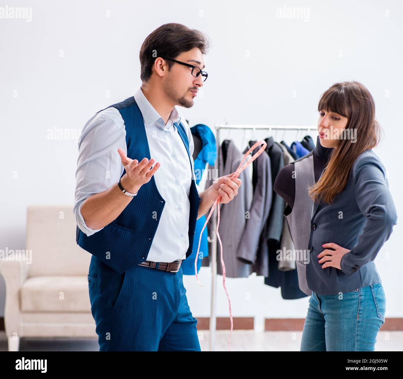 The professional tailor taking measurements for formal suit Stock Photo ...