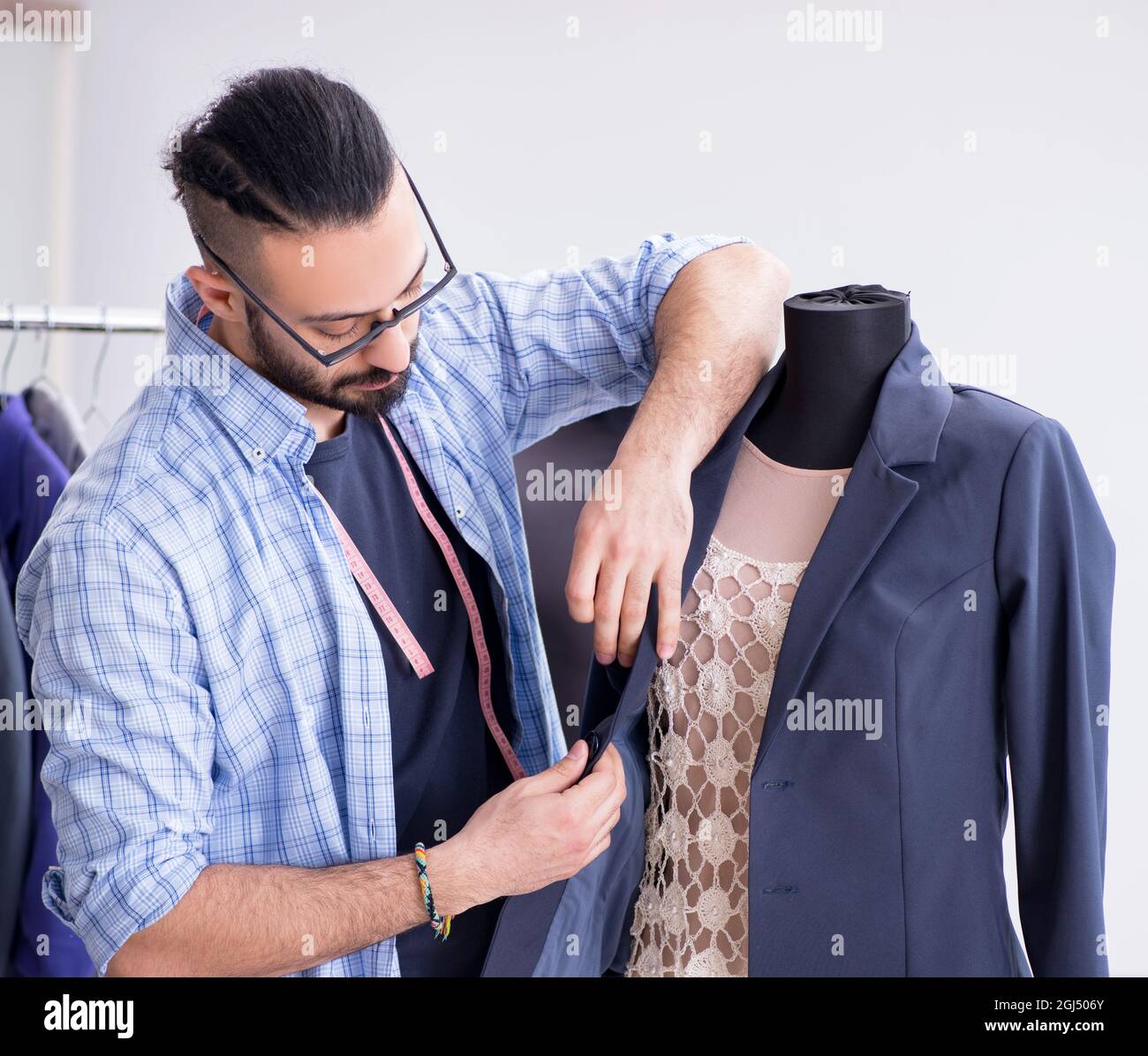 The male tailor working in the workshop on new designs Stock Photo - Alamy