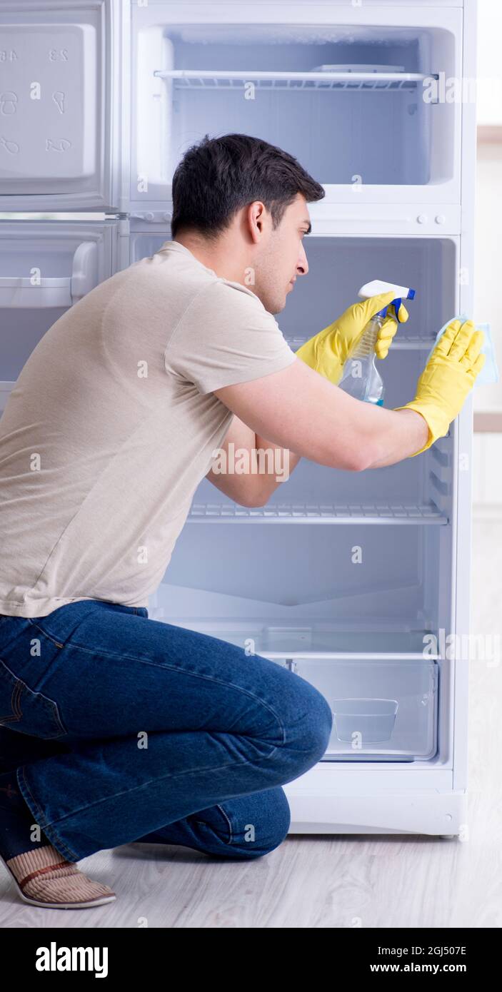 The man cleaning fridge in hygiene concept Stock Photo - Alamy