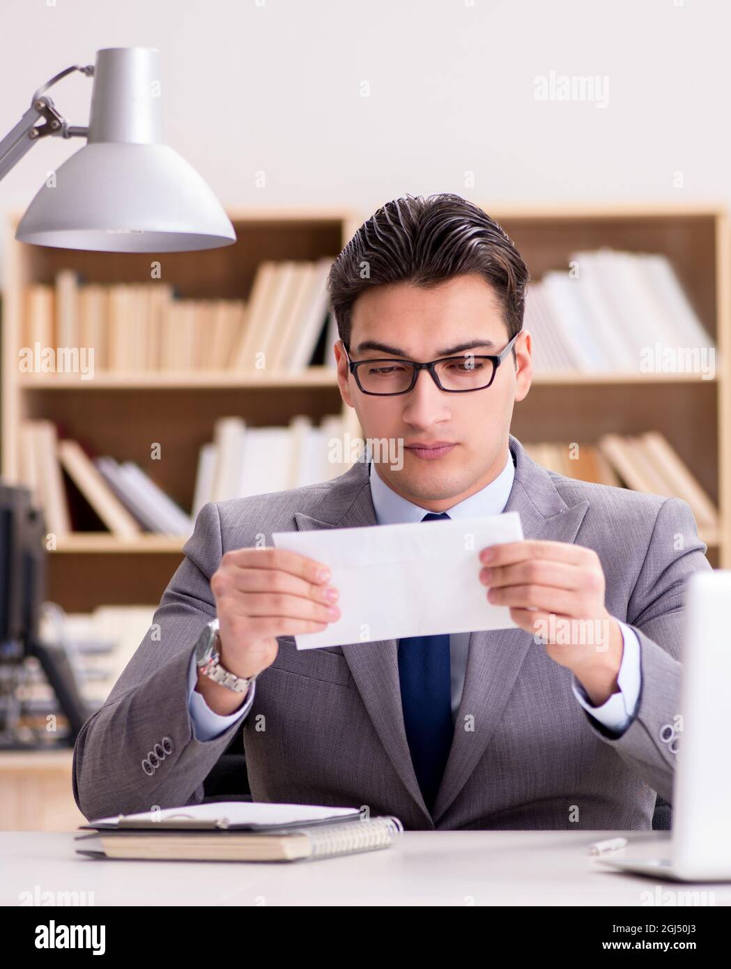 The businessman receiving letter in the office Stock Photo - Alamy