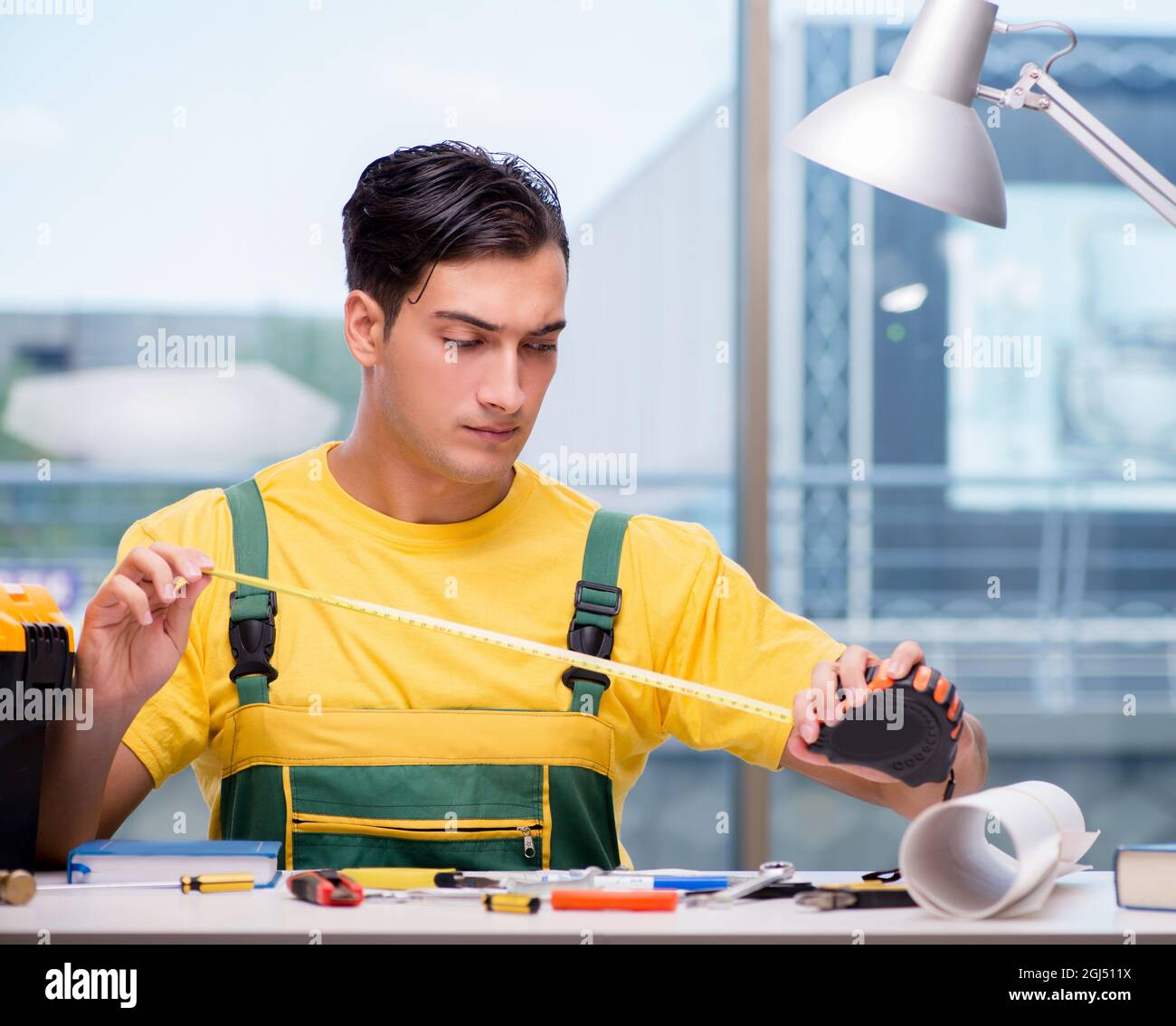The construction worker sitting at the desk Stock Photo - Alamy