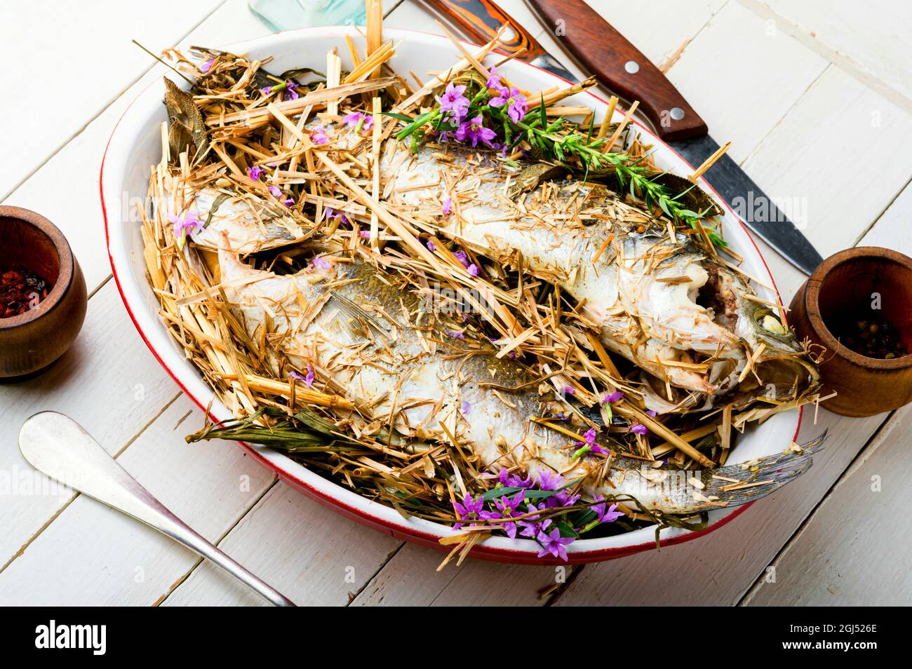 Fish baked in herbs and meadow hay. Roasted sea bass Stock Photo - Alamy