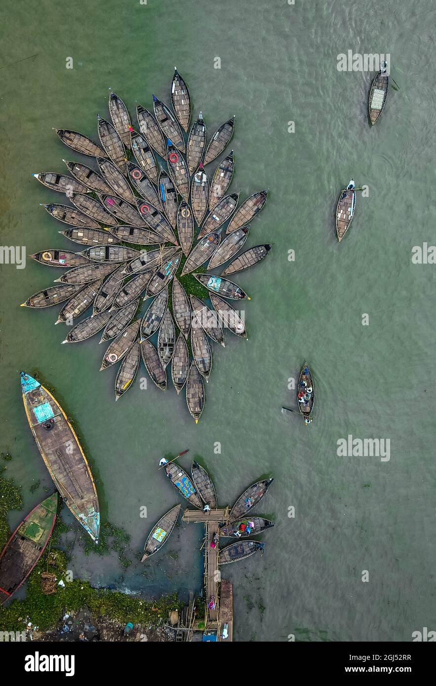 Aerial view of Hundreds of wooden boats resemble like flowers in Buriganga River Port. The boats ...