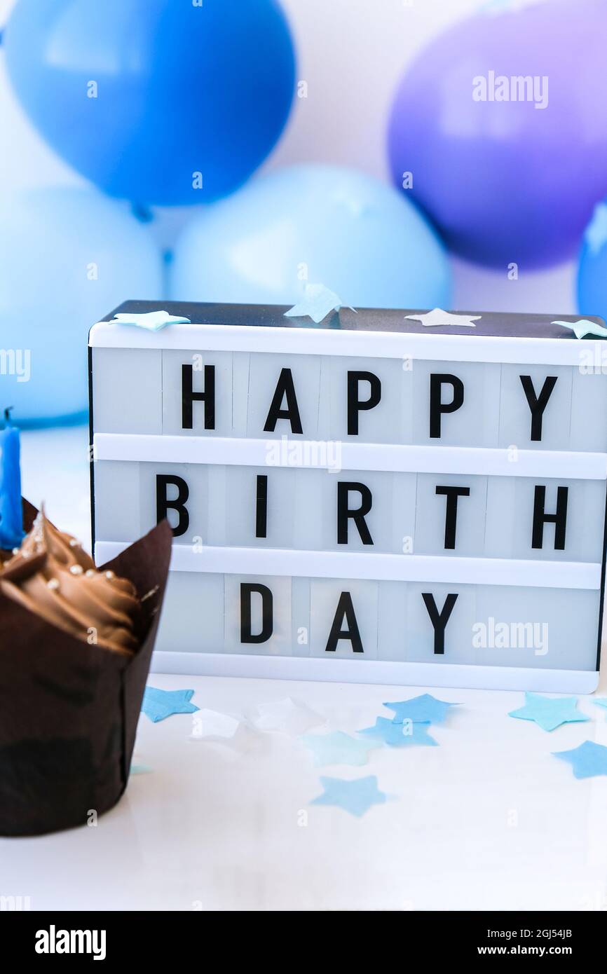 Lightbox with text HAPPY BIRTHDAY and chocolate cupcake candle on ...