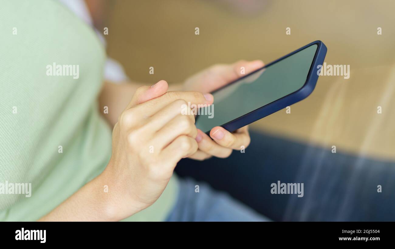 Millennial woman holding smart phone watching video, playing game ...