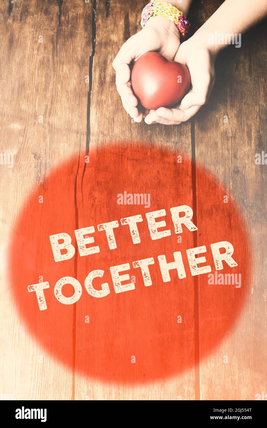better together slogan printed on vintage wooden board with red heart ...