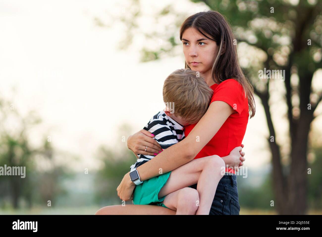 Frustrated school-age son hugged his mother chest. Warm family hugs ...