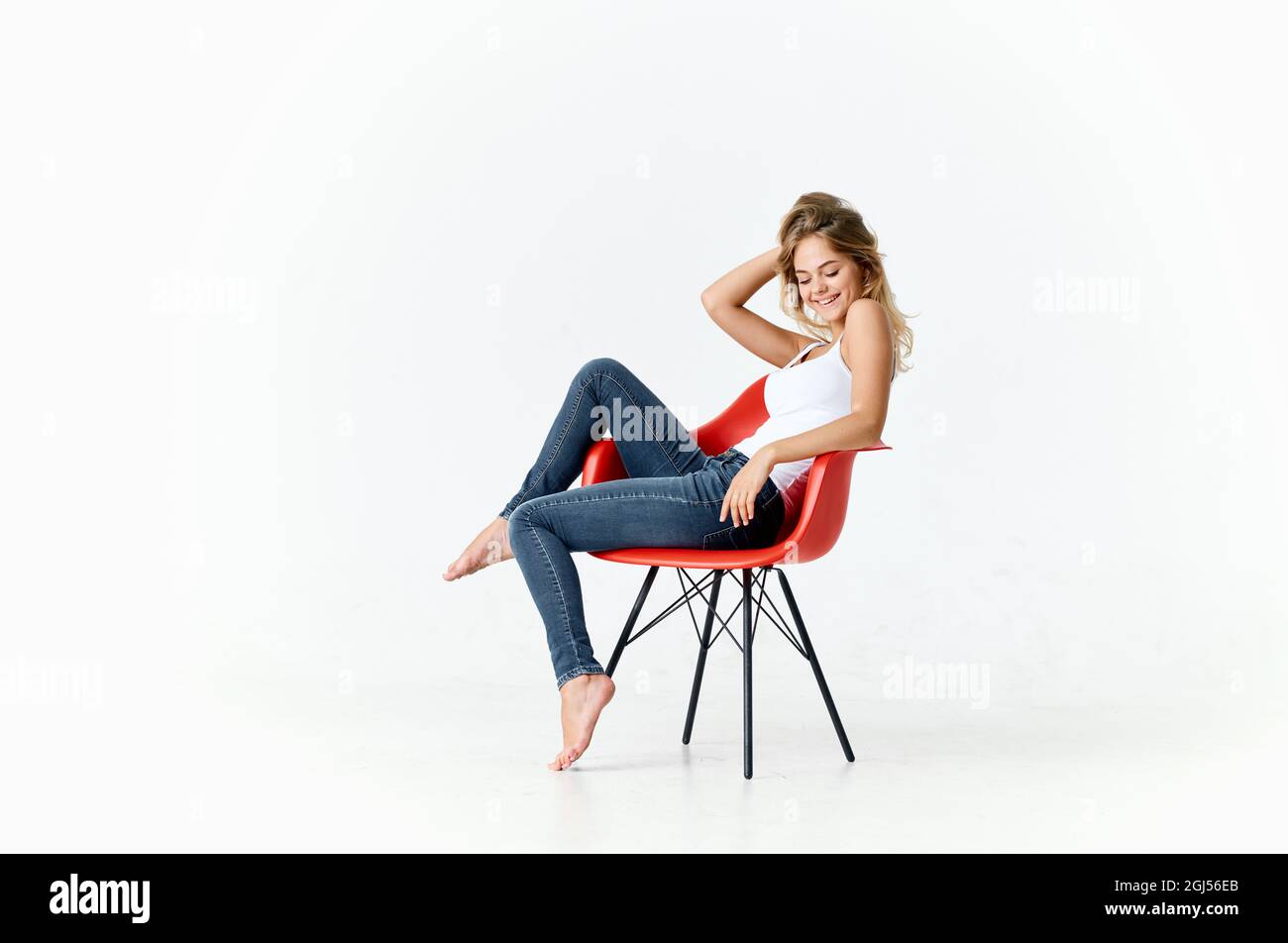 Woman posing red chair Cut Out Stock Images & Pictures - Alamy