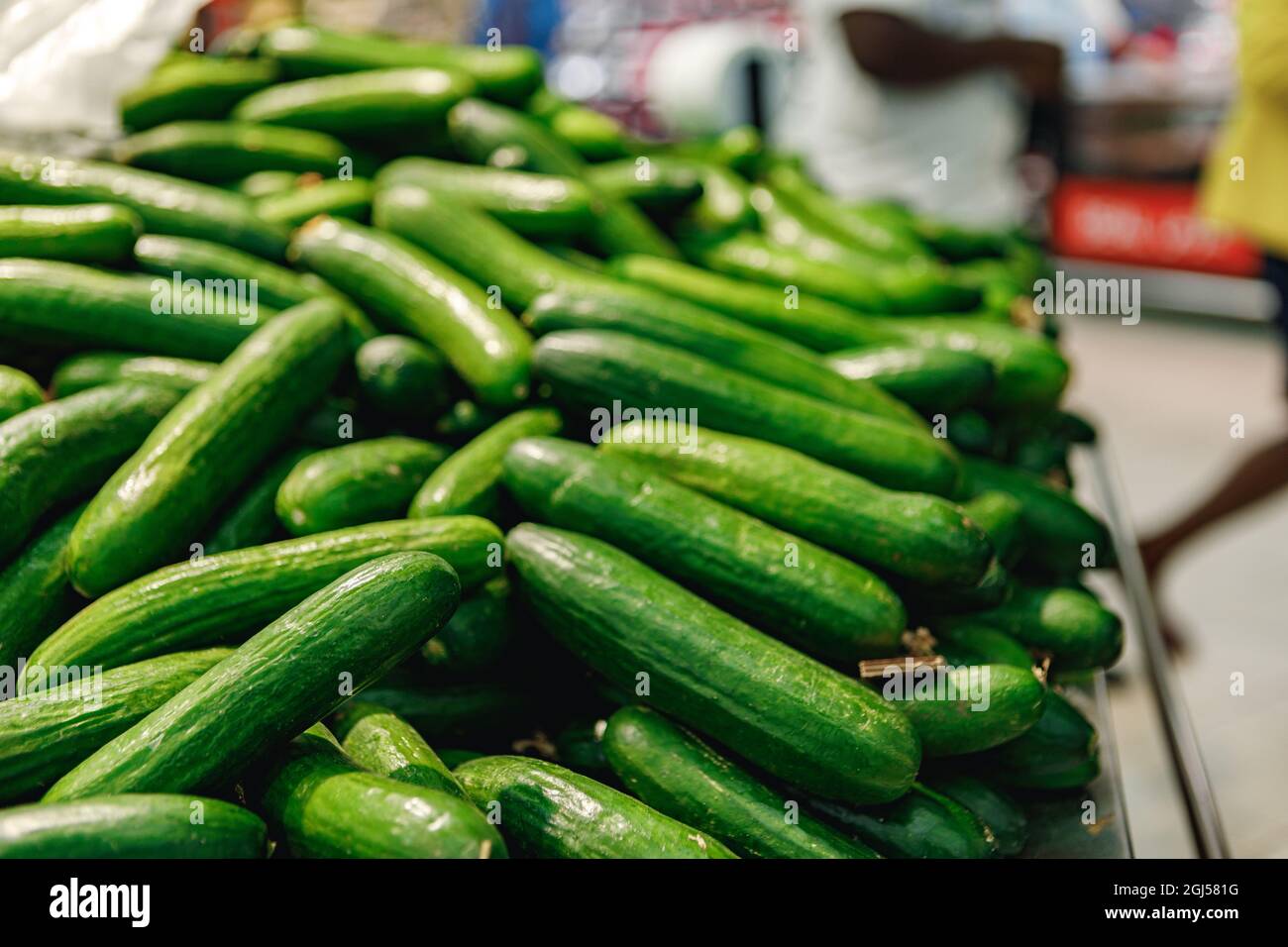 Pile of fresh cucumbers on counter in supermarket Stock Photo - Alamy