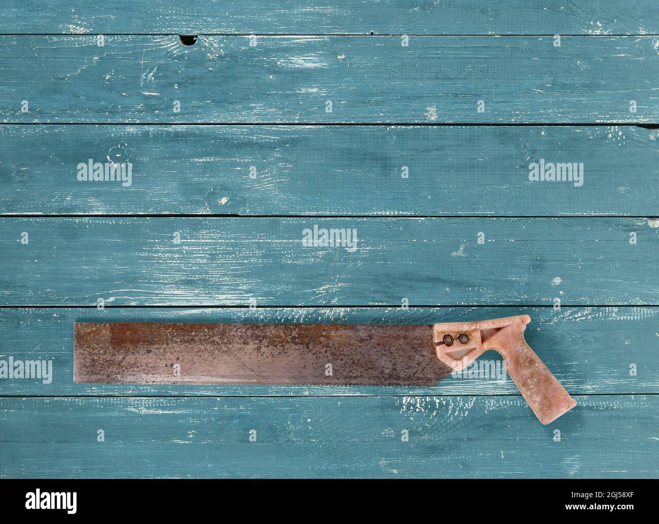 Tools Building and repair - Top view Old rusty hand saw on a blue ...