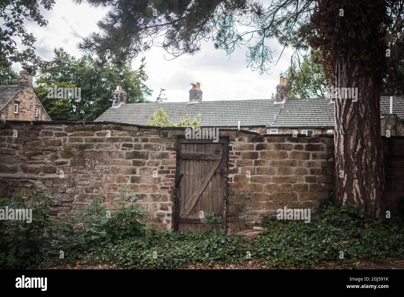 Secret wooden gate entrance to garden of old stone cottage closed ...