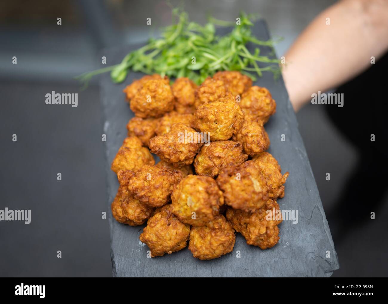 Delicious platter of Asian onion bhaji starter food snacks at wedding ...