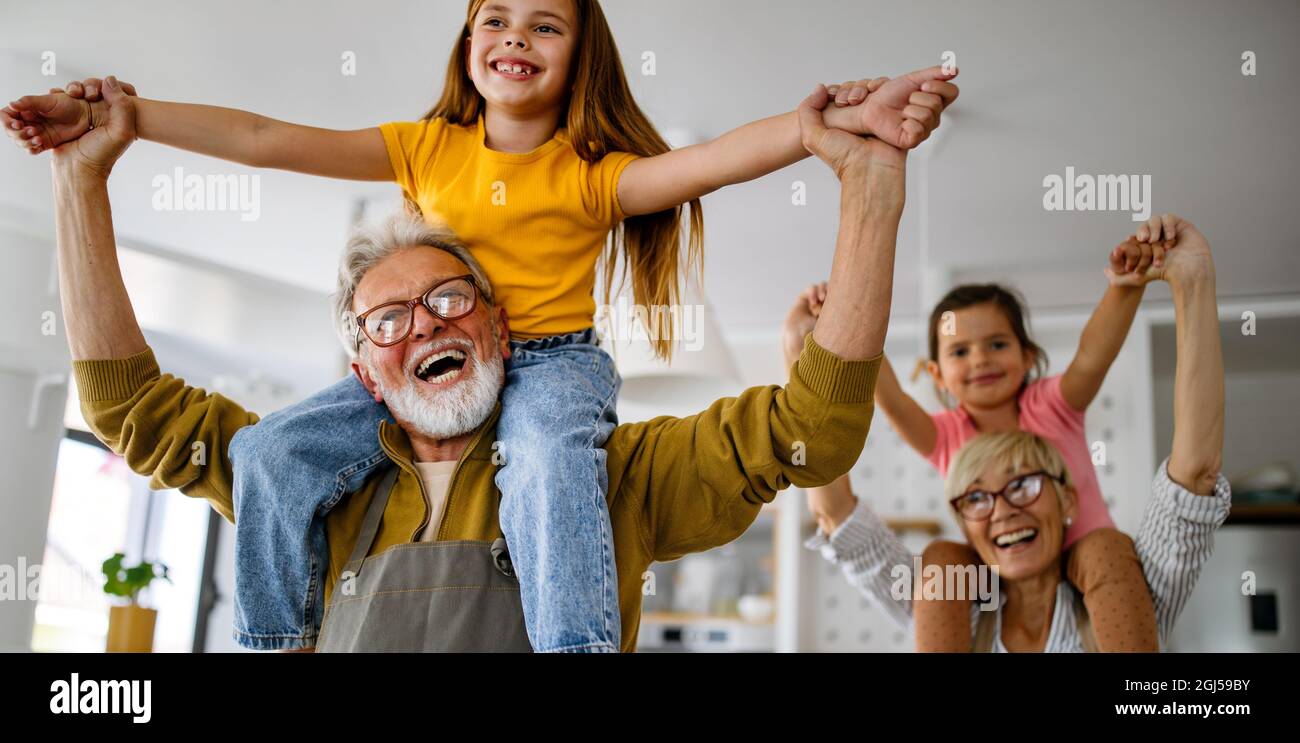 Happy grandparents having fun times with children at home Stock Photo ...
