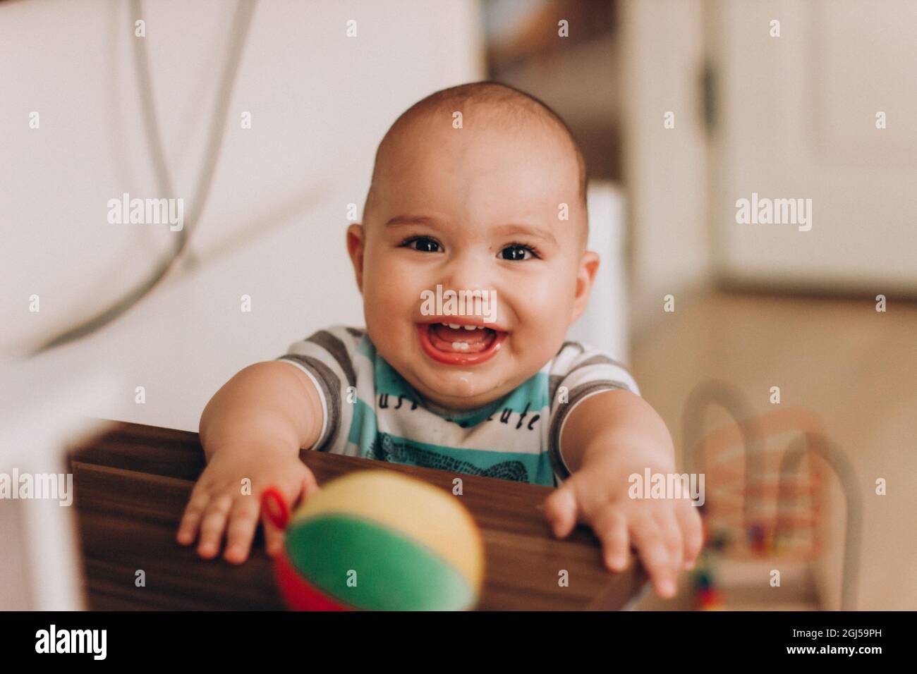 Portrait of cute baby close-up. Sweet little infant looks to camera ...
