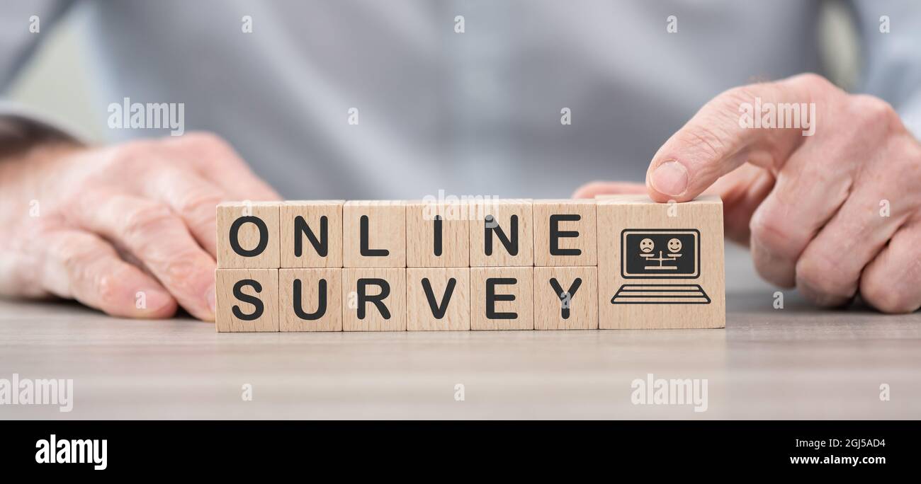 Wooden blocks with symbol of online survey concept Stock Photo - Alamy