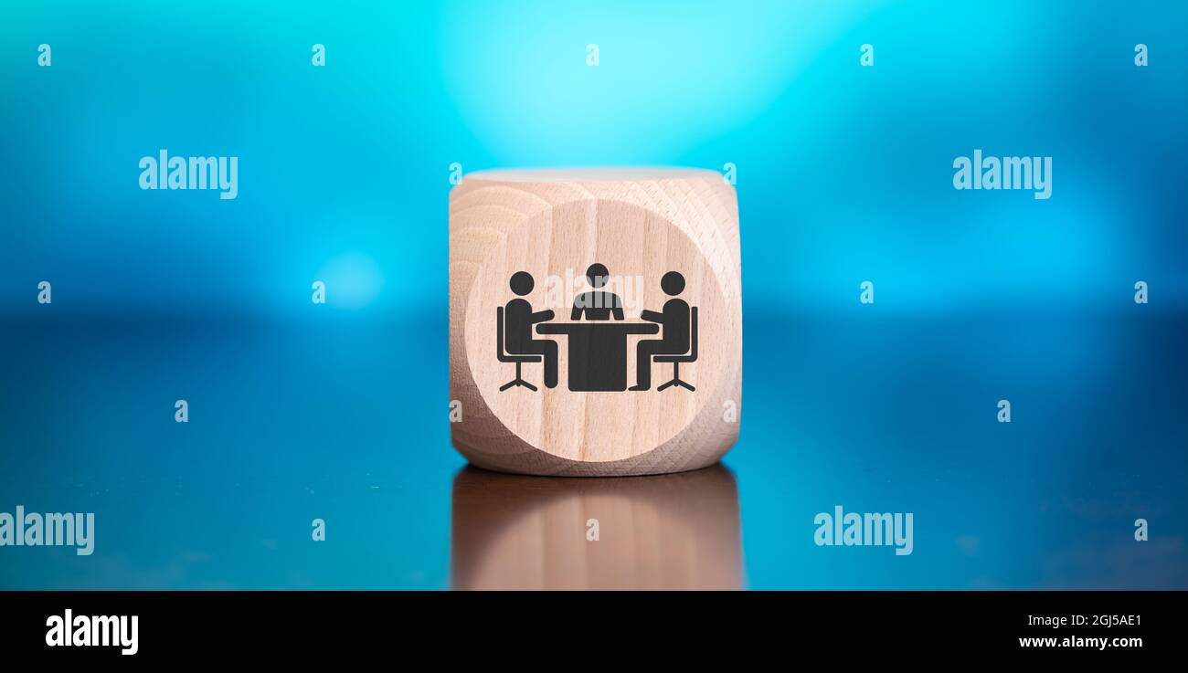 Wooden block with symbol of meeting concept on blue background Stock ...